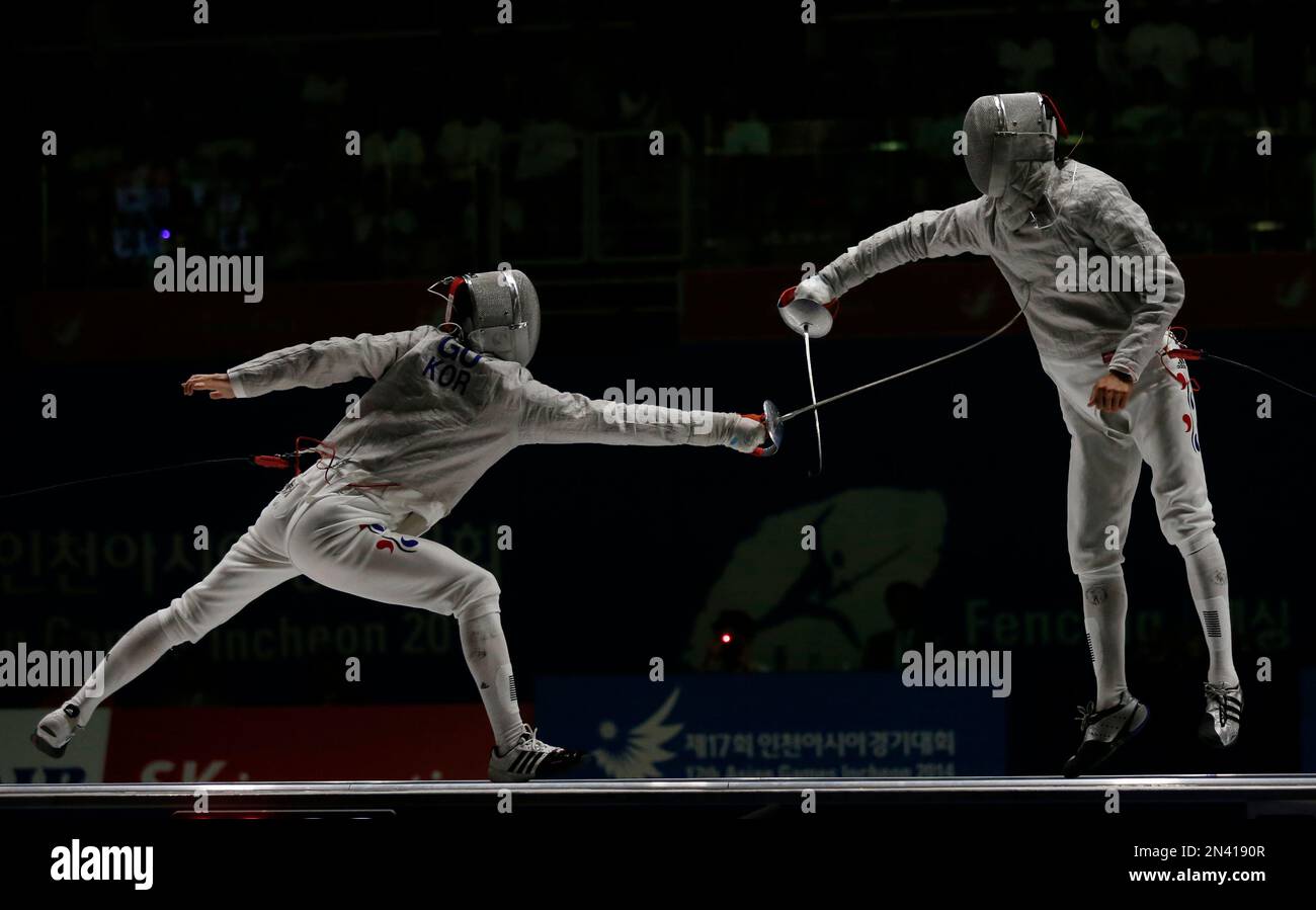 South Korea's Gu Bongil, left, competes with South Korea's Kim Junghwan ...