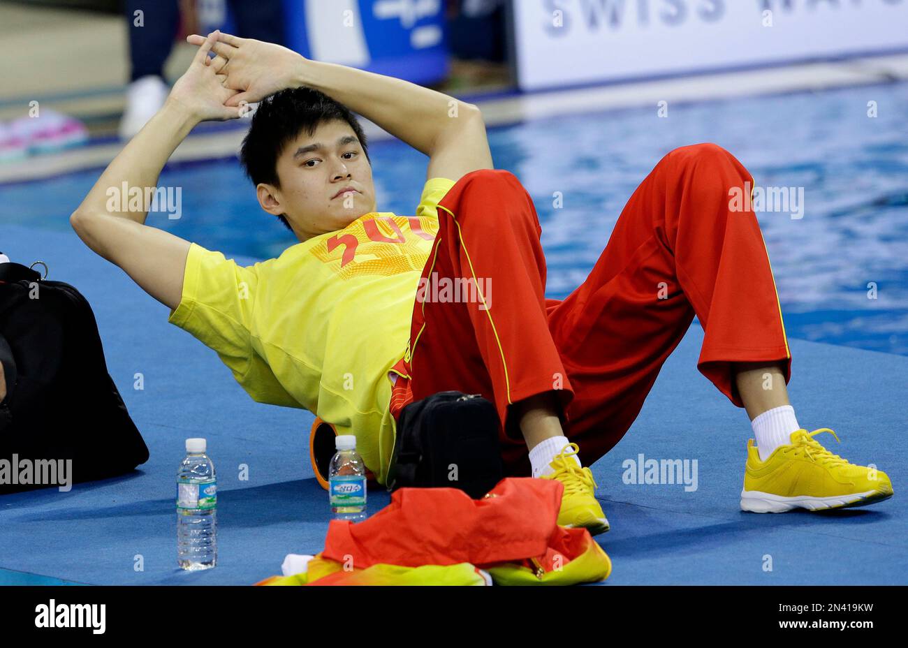 China's Sun Yang stretches during a warm-up ahead of the men's 200 ...