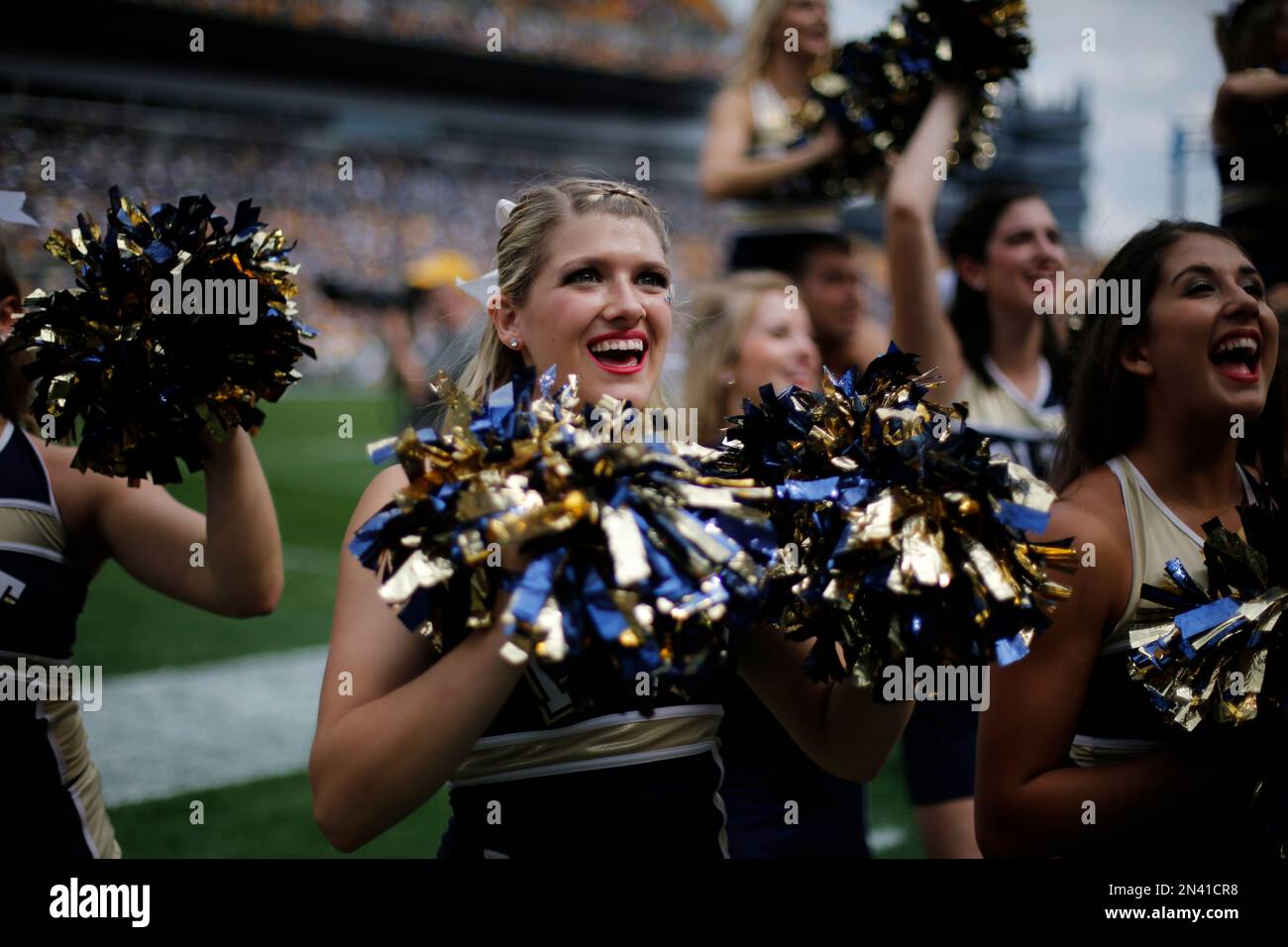 University of Pittsburgh cheerleaders cheer in front of the student ...