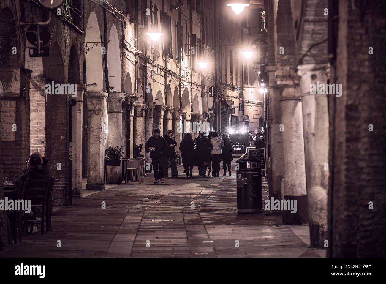 Ferrara, Italy 5 February 2023: People walking in a narrow street ...