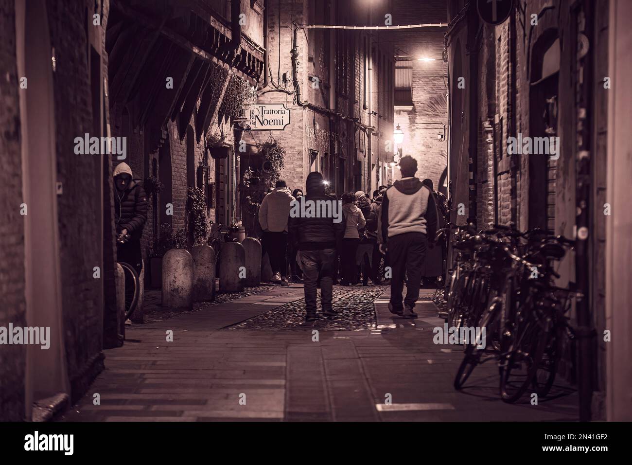 Ferrara, Italy 5 February 2023: People walking in a narrow street ...