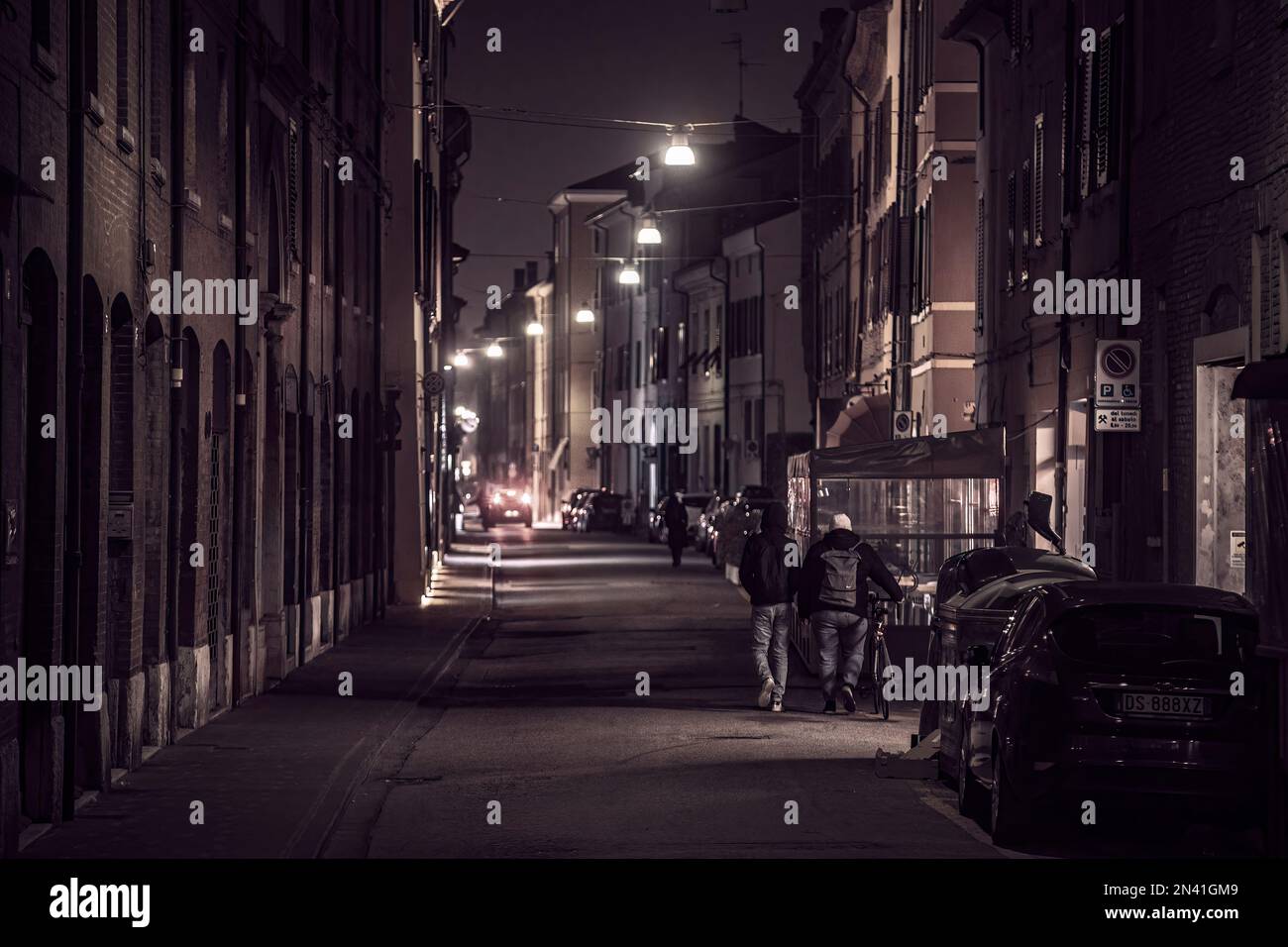 Ferrara, Italy 5 February 2023: People walking in a narrow street ...