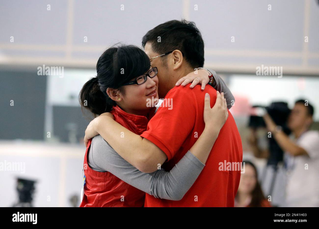 China's Mengyuan Zhang celebrates with her coach after winning the Gold ...