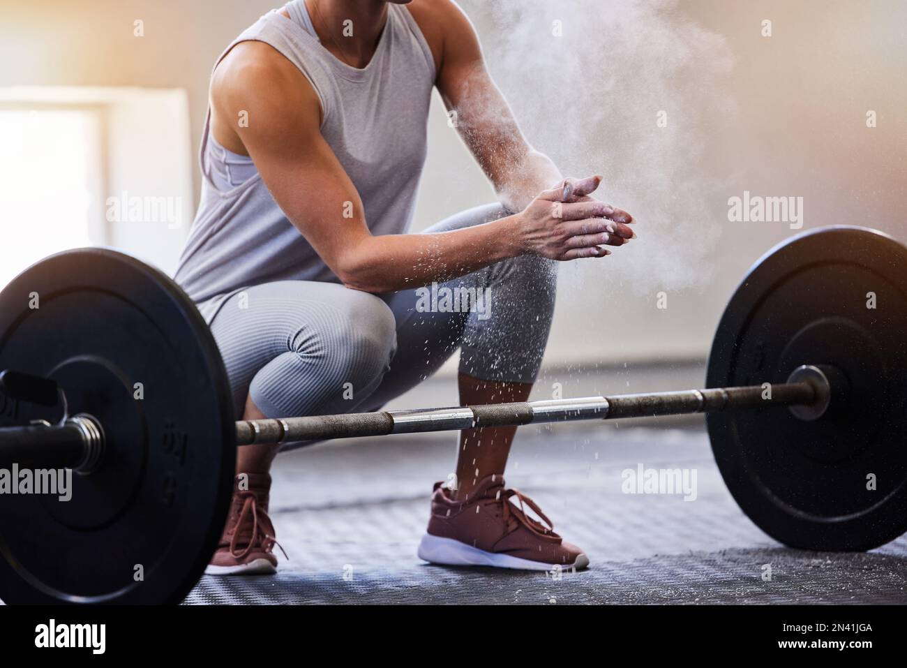 Hands, bodybuilding and powder with a woman weight lifter getting ready ...