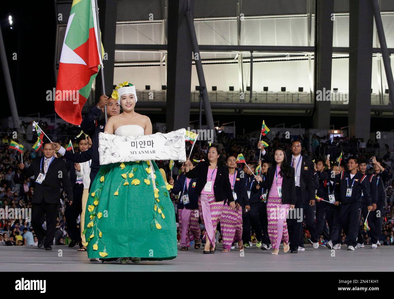 Myanmar's Yan Naing Soe carries his national flag to lead his team into Incheon Asiad Main ...