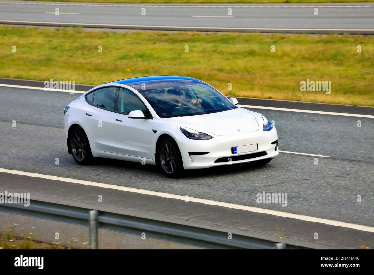 White Tesla Model 3 electric car at speed on motorway. Salo, Finland ...