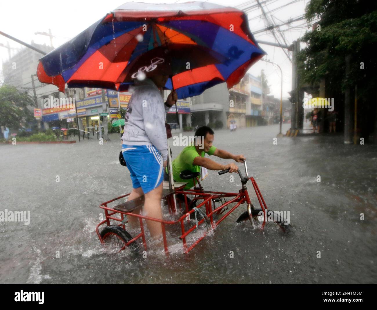 A commuter is ferried on a three-wheeled tricycle locally known as ...