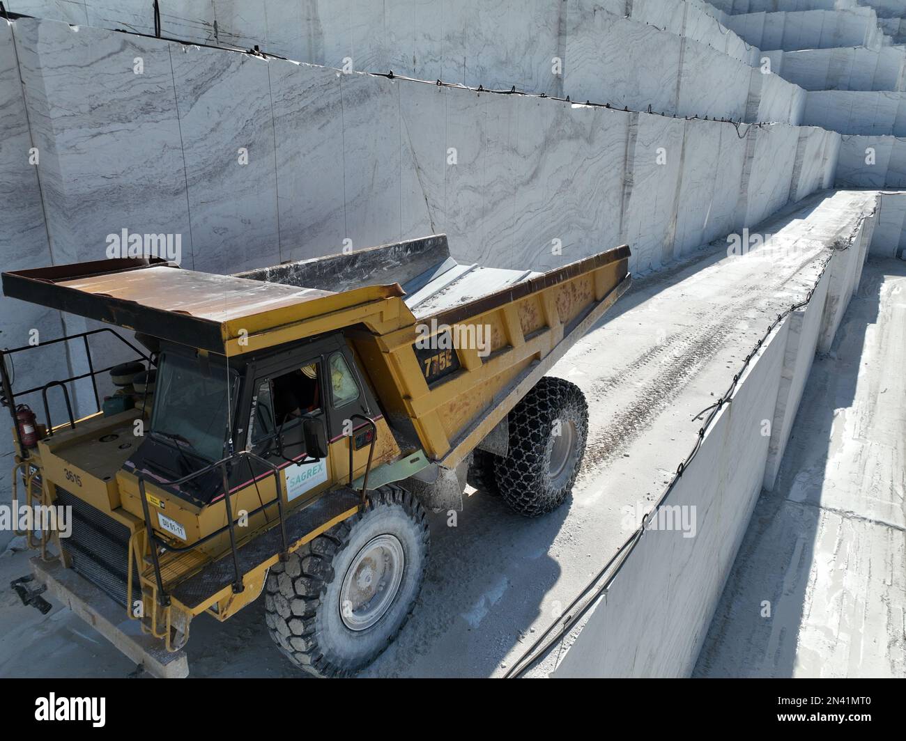 Wheel loaders working on huge marble quarry Stock Photo - Alamy
