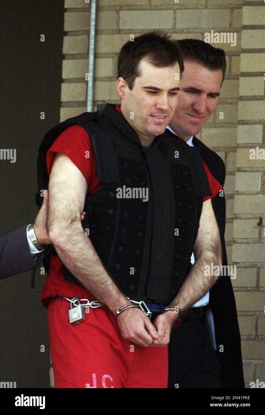 FILE - In this June 22, 2004 file photo, Eric Rudolph is led from a ...