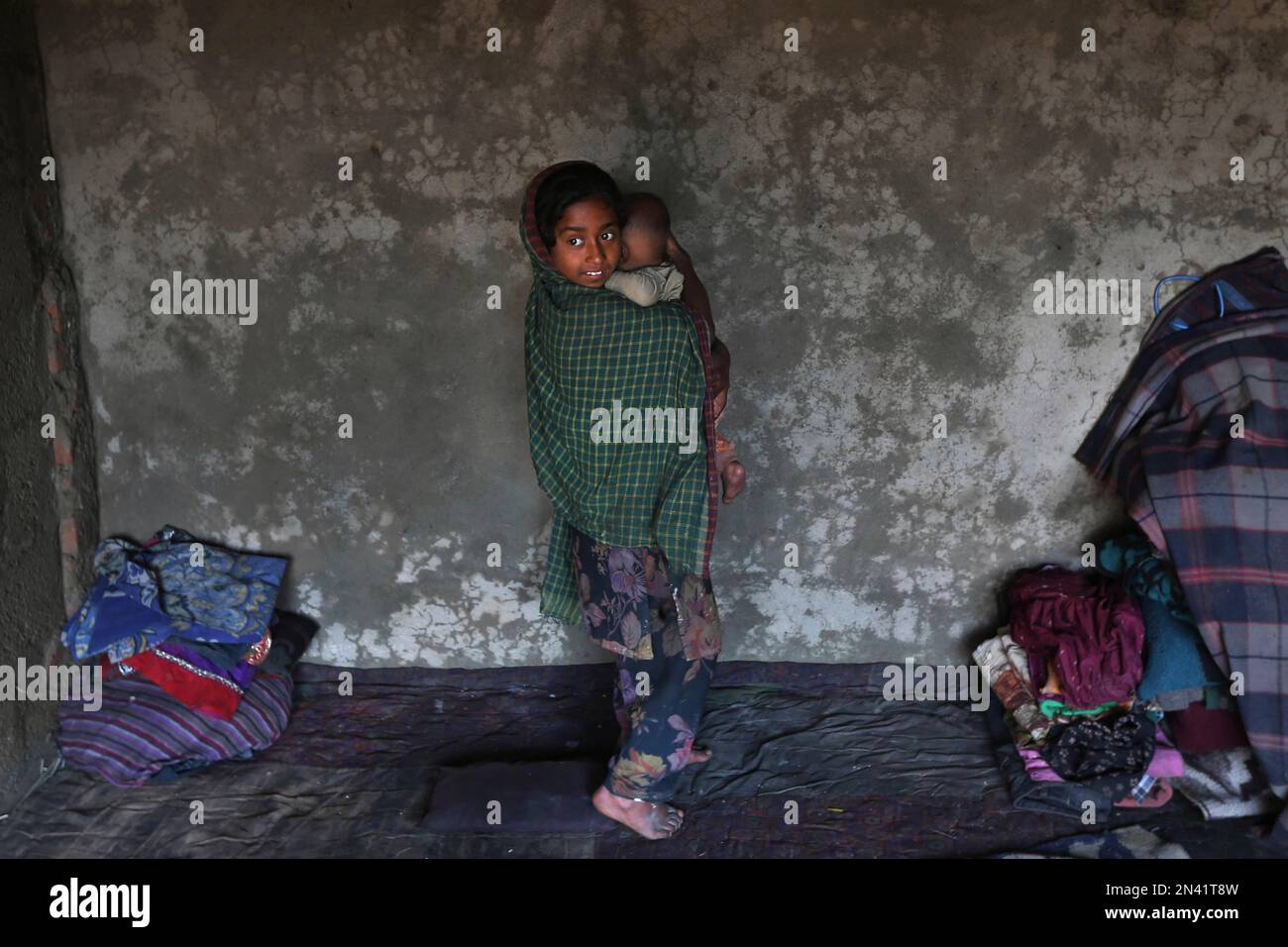 An Indian girl, part of a family of migrant workers who were displaced ...
