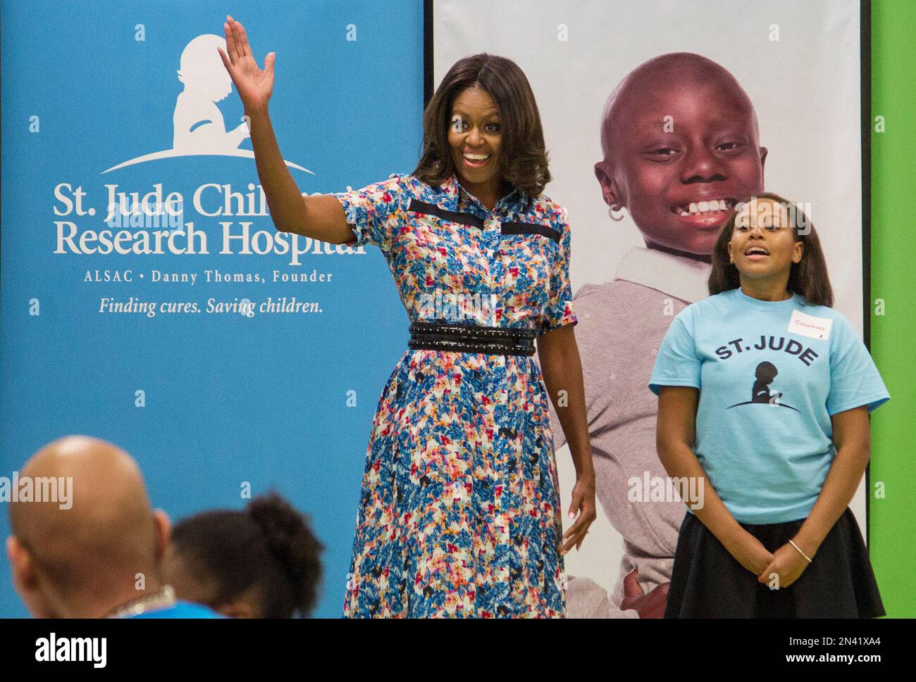 First lady Michelle Obama waves as she is introduced by Courtney Davis ...