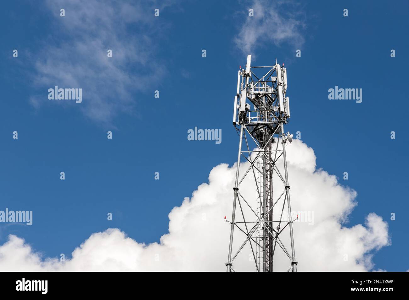 Bottom perspective pov of modern metal steel mobile 5g network wireless telecom tower against ...