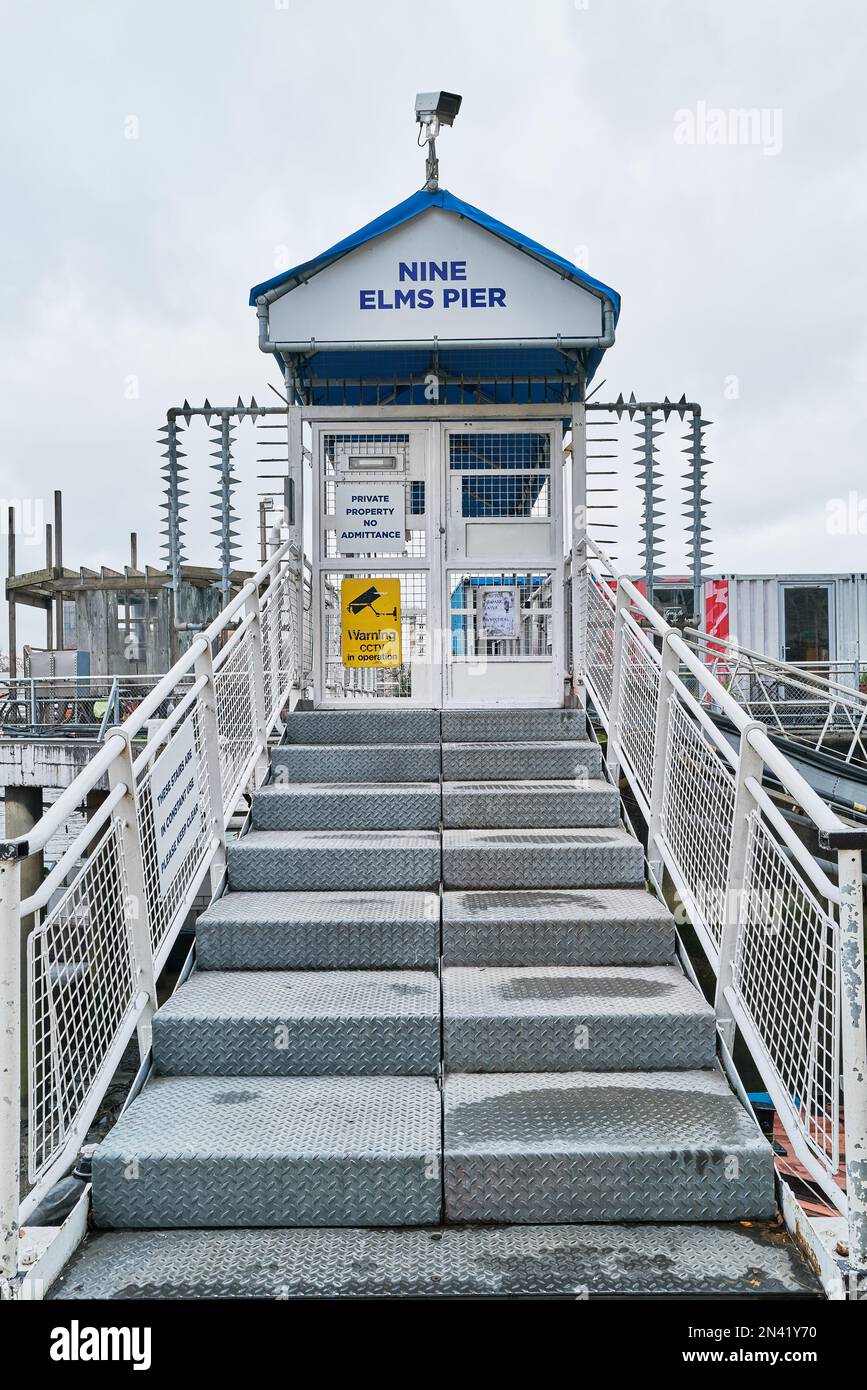 Steps to the entrance of Nine Elms pier on the bank of the river Thames ...