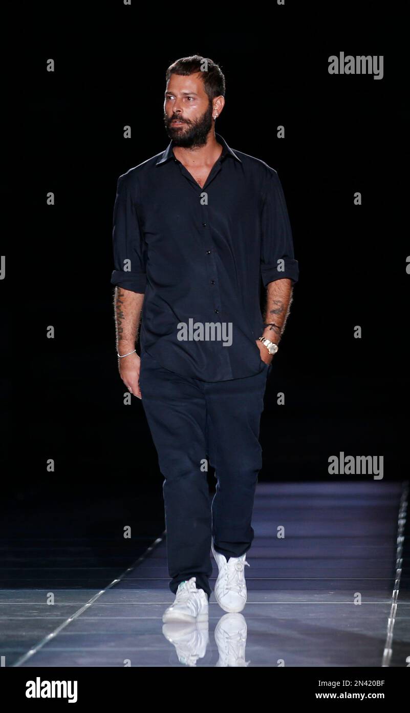 Italian fashion designer Fausto Puglisi walks on the catwalk at the end ...