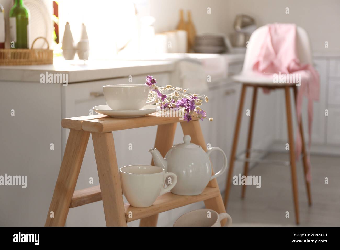 Decorative ladder with different dishware in kitchen. Idea for interior ...