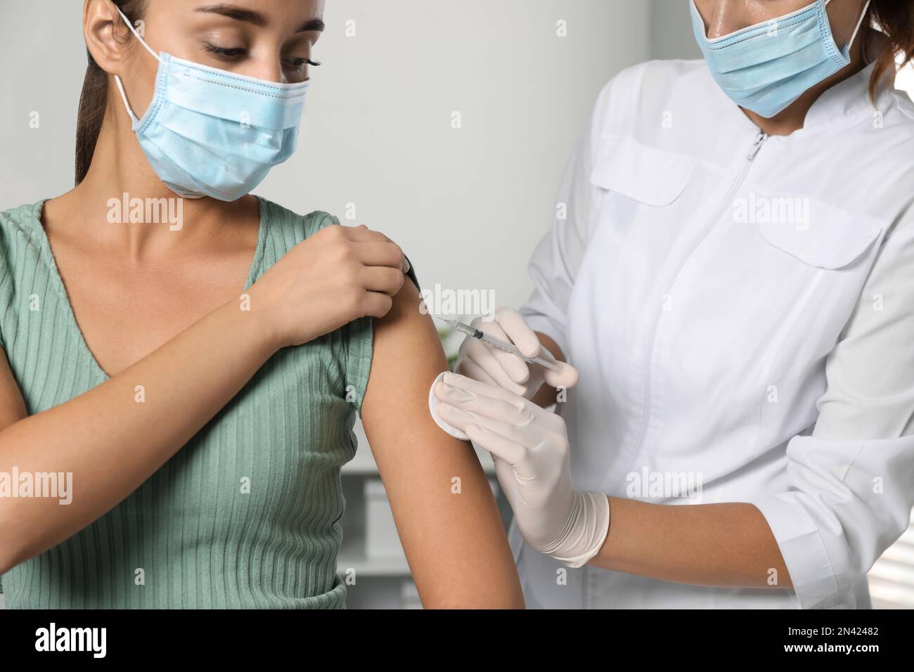 Doctor giving injection to patient in hospital, closeup. Vaccination ...
