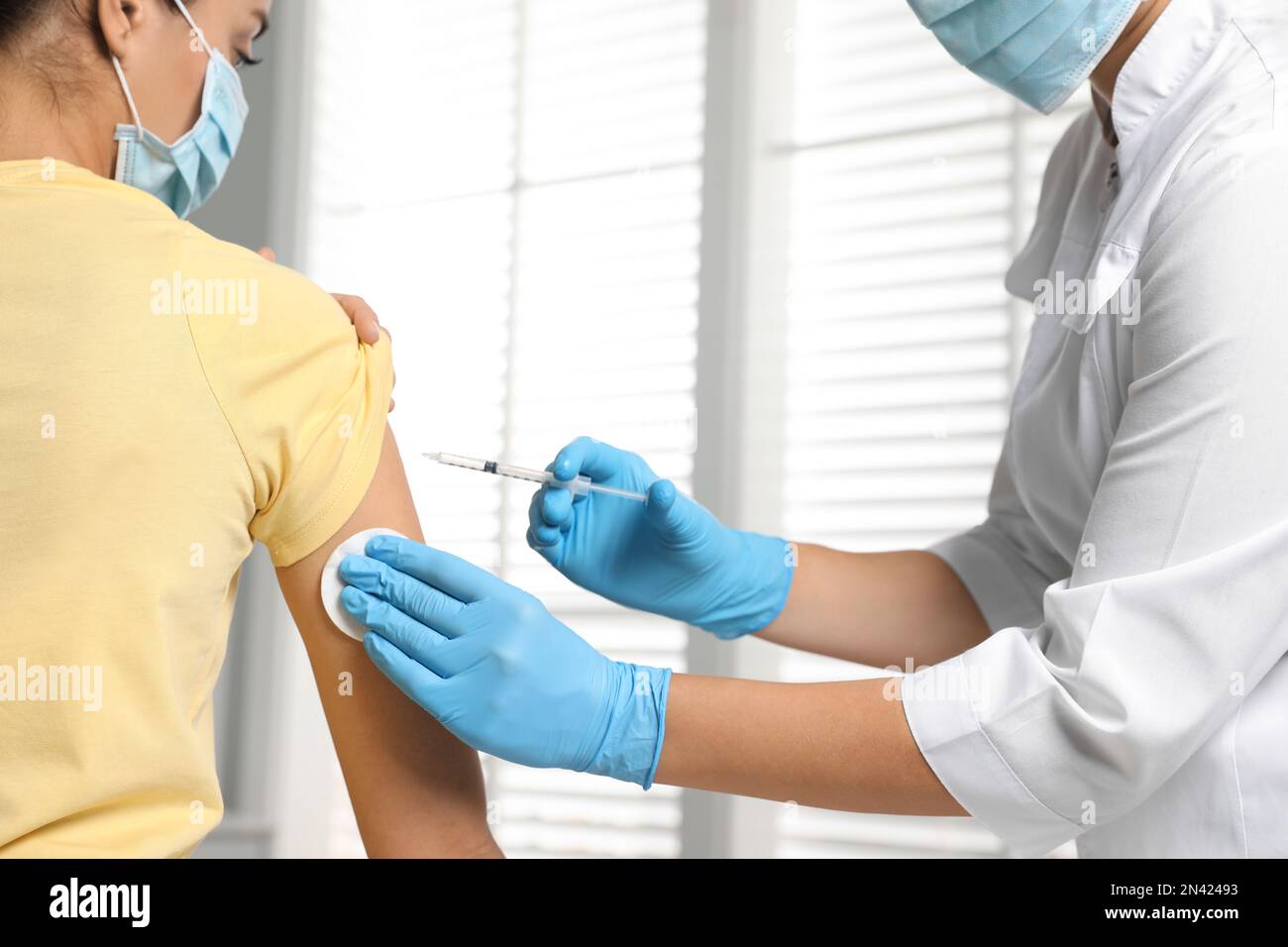 Doctor giving injection to patient in hospital, closeup. Vaccination ...