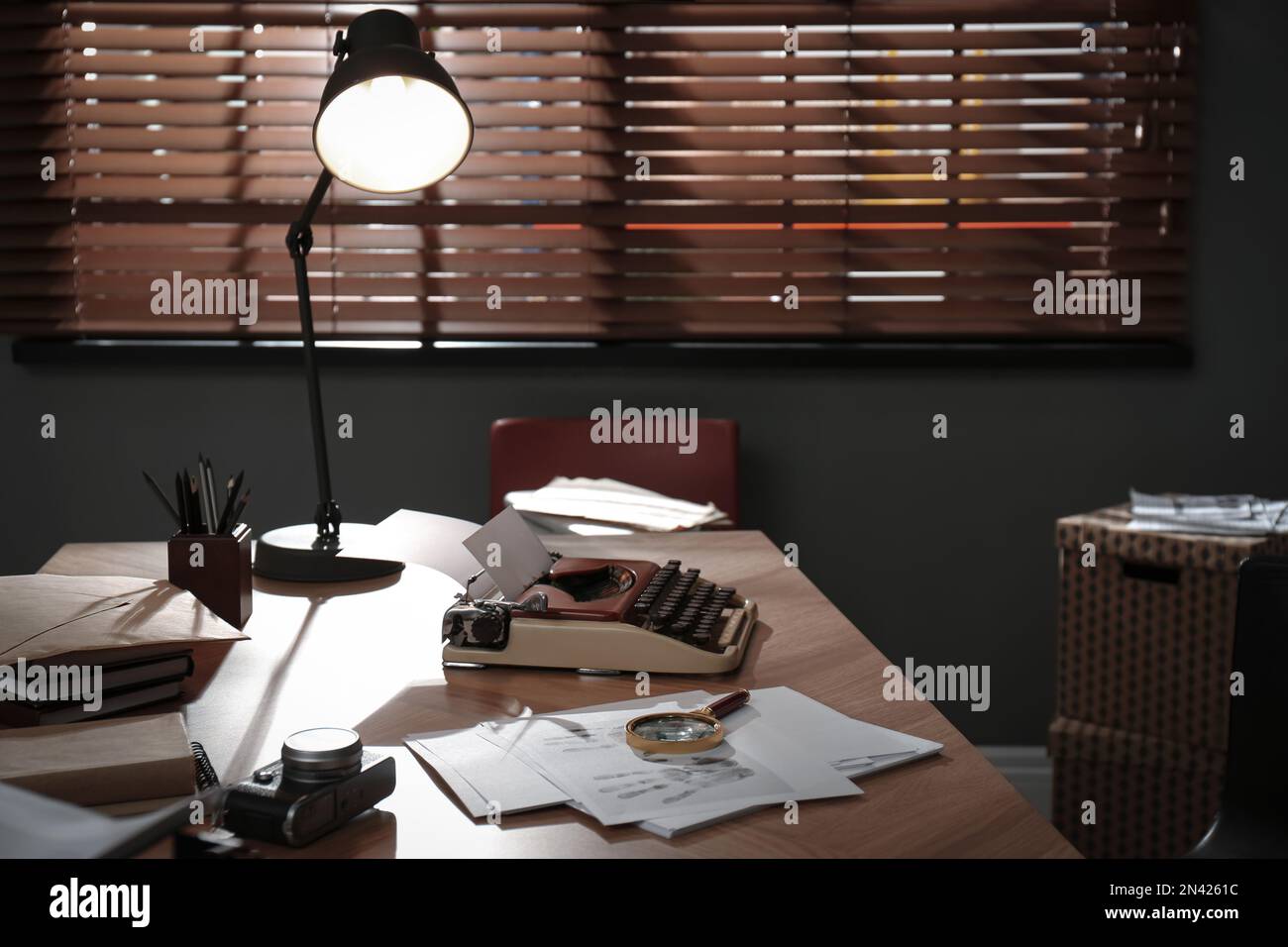 Typewriter, fingerprints and papers on desk in office. Detective's ...