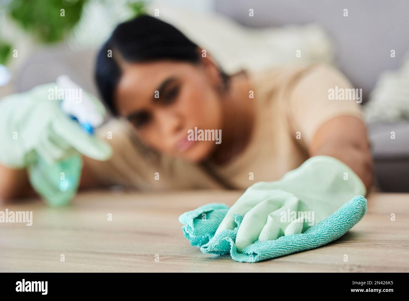 Hand, cleaning and cloth with a woman housekeeper wiping a wooden ...
