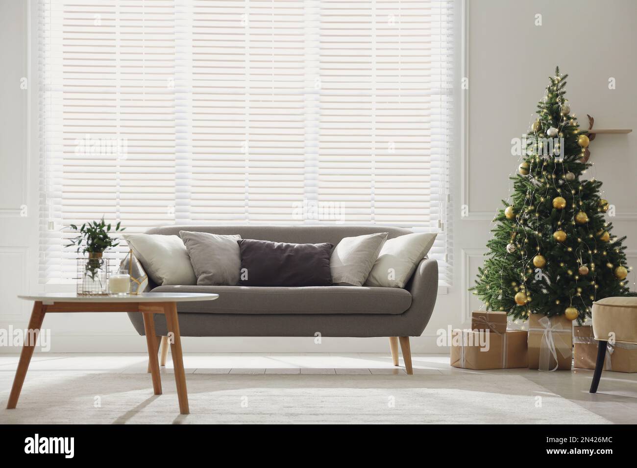 Beautiful Christmas tree and sofa in contemporary living room. Interior ...