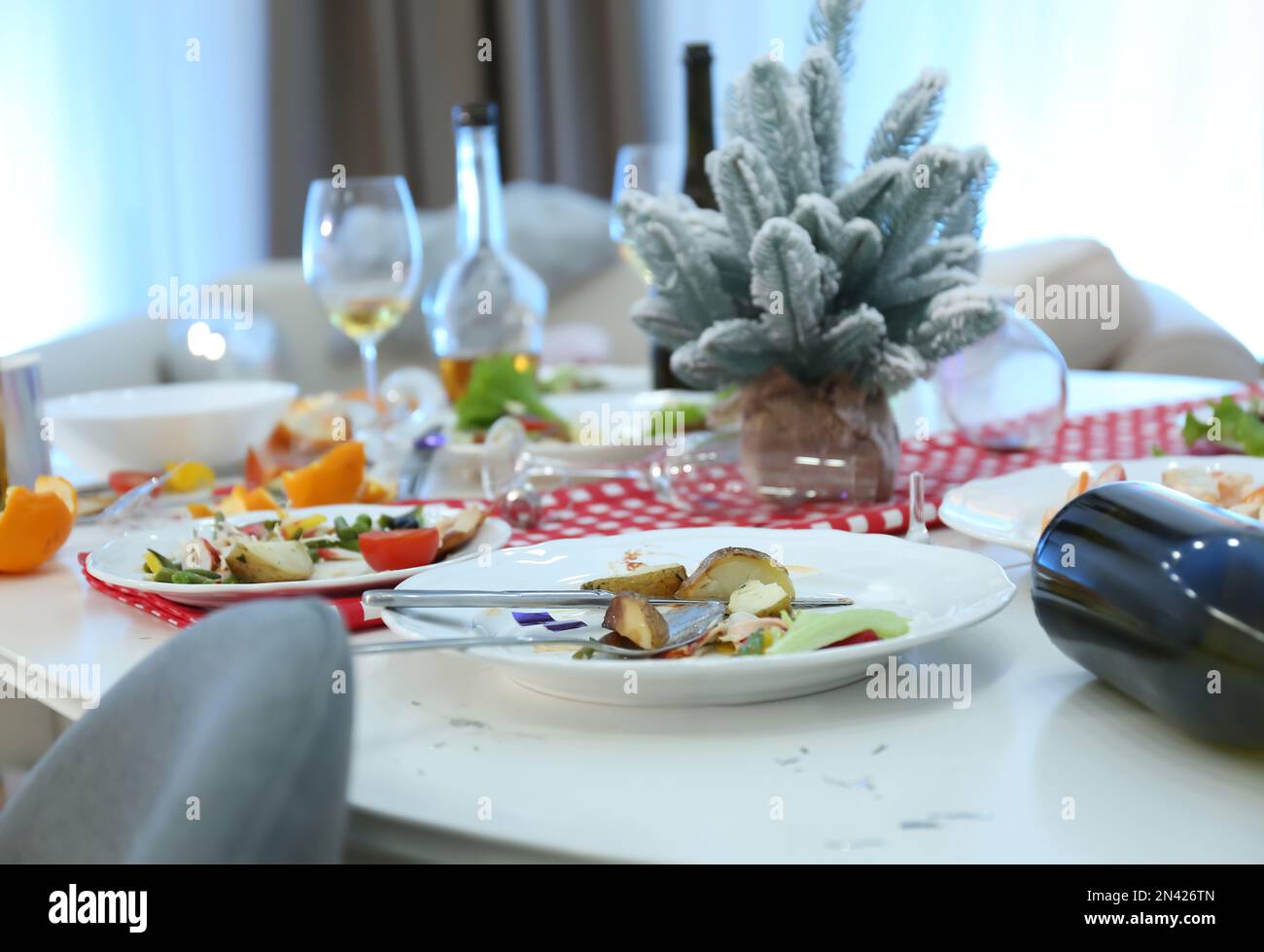 Dirty dishes on white table in room. Mess after new year party Stock ...