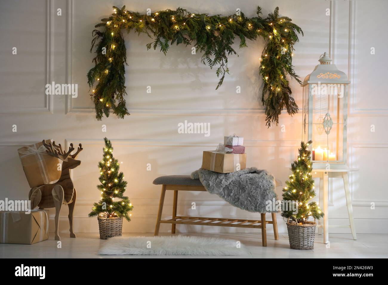 Beautiful Christmas themed photo zone with fir decor Stock Photo - Alamy