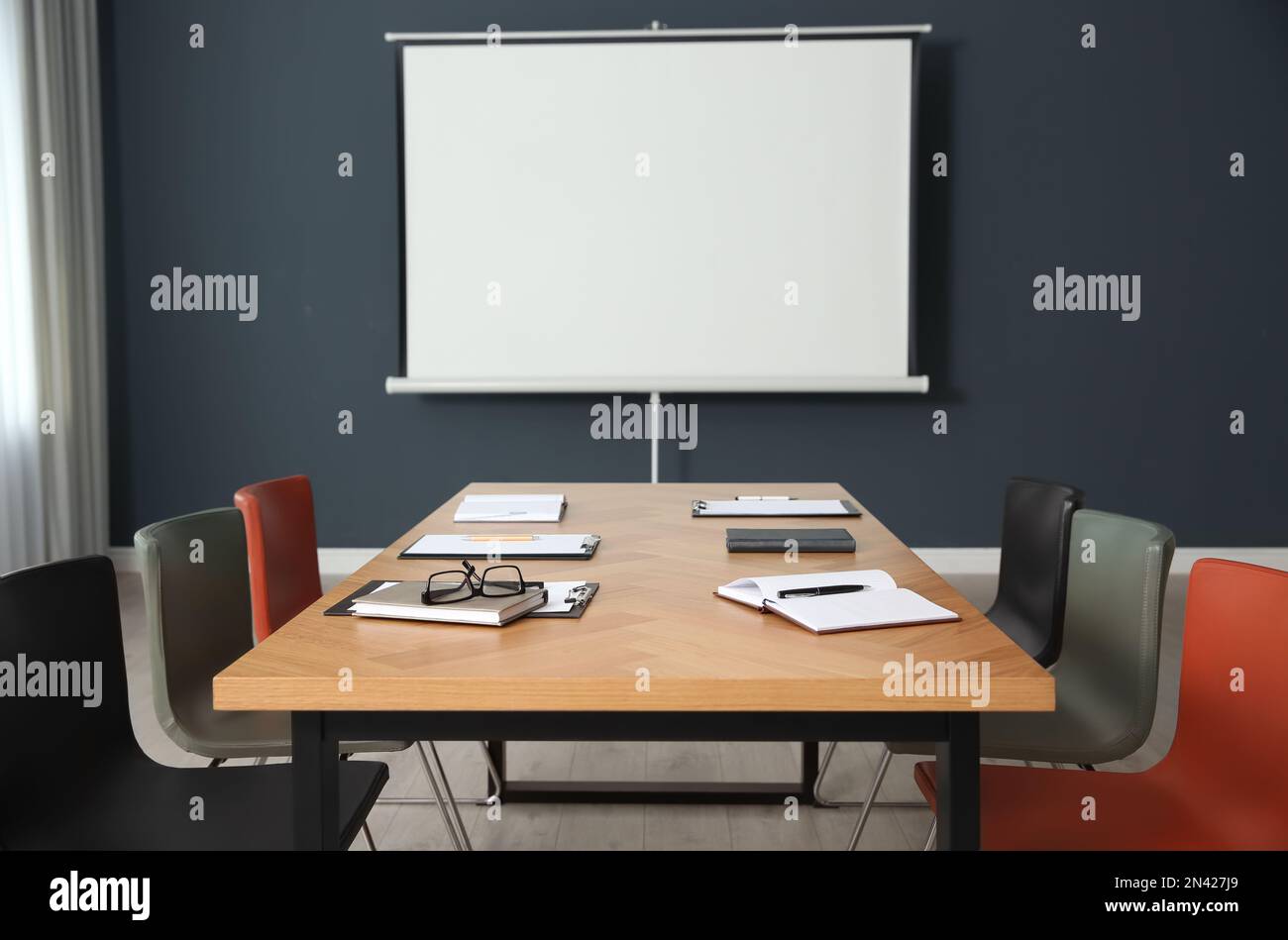 Modern meeting room interior with large table and projection screen ...