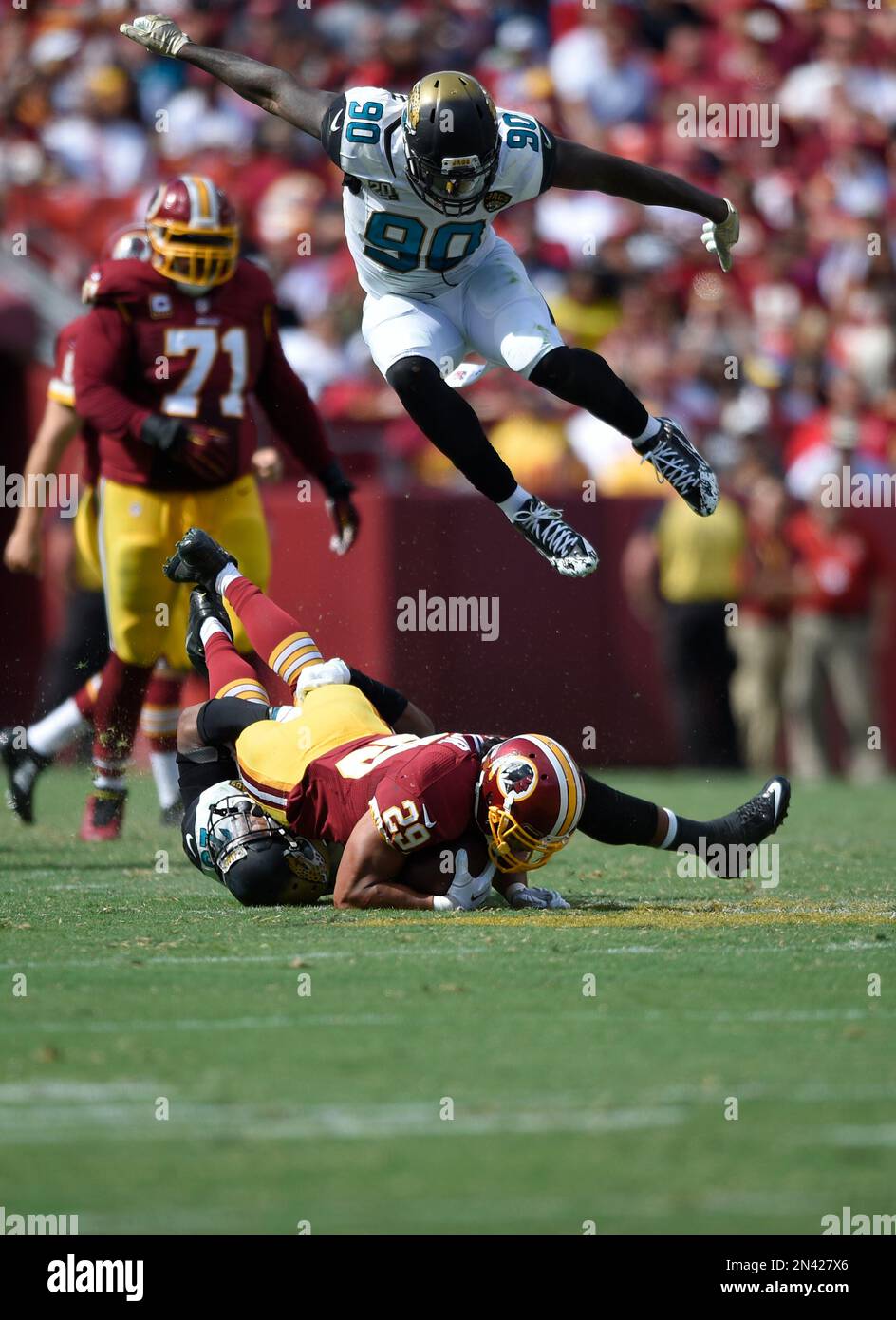 Jacksonville Jaguars defensive end Andre Branch (90) leaps over a ...