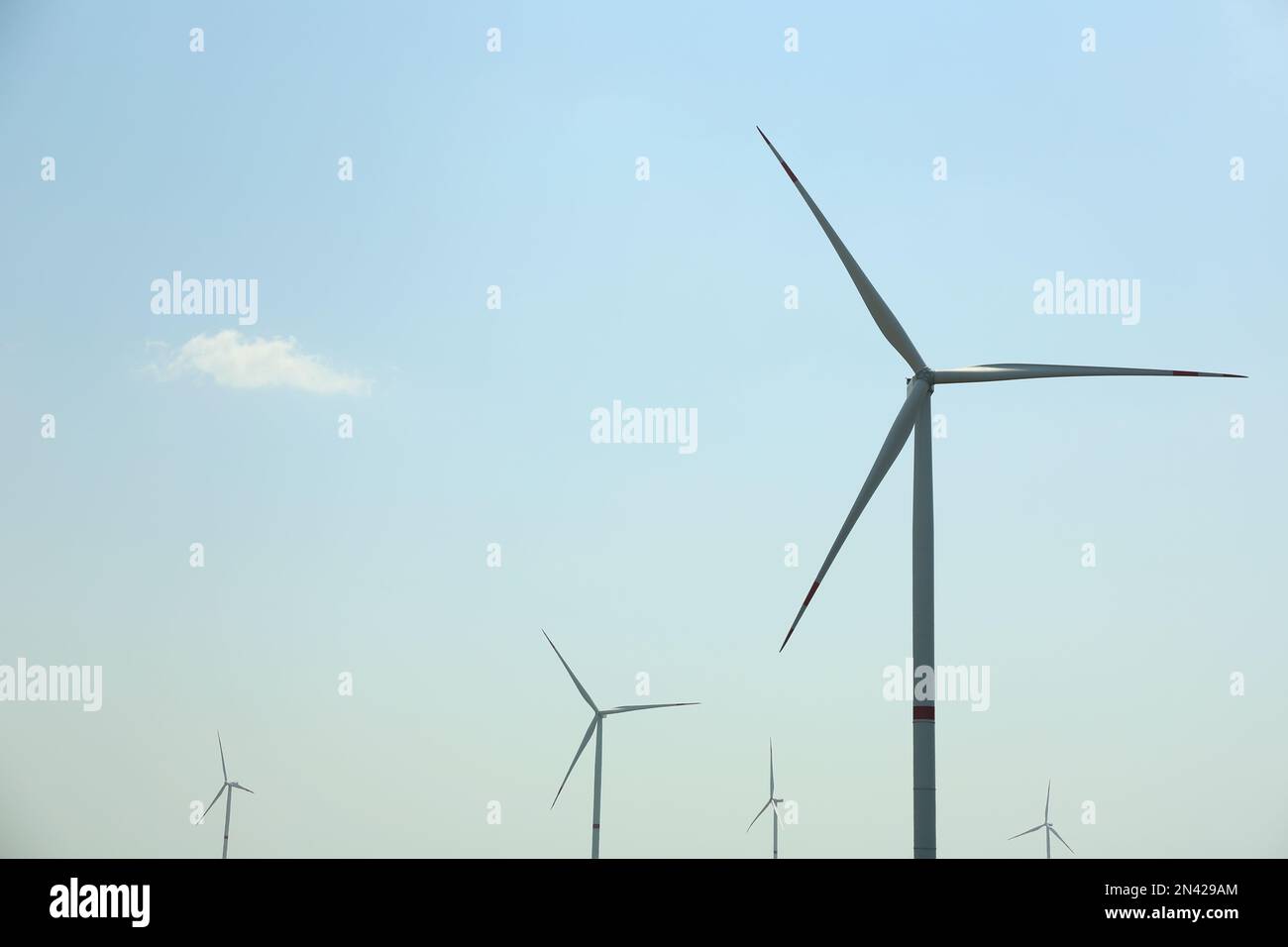 Modern wind turbines against blue sky. Energy efficiency Stock Photo ...