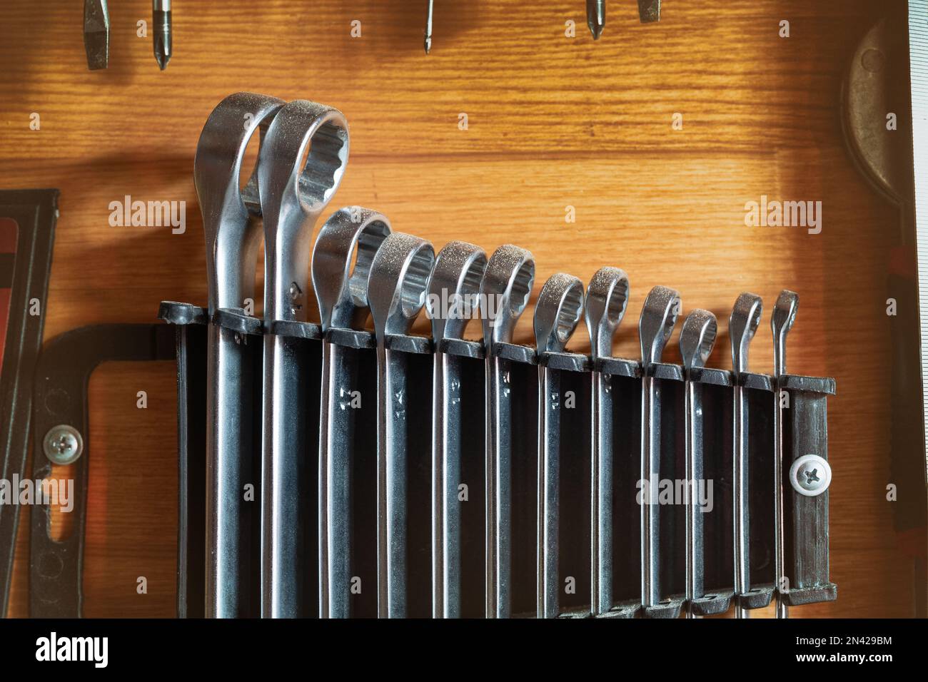 Set of used metal steel ring wrench organized and hanged in plastic ...
