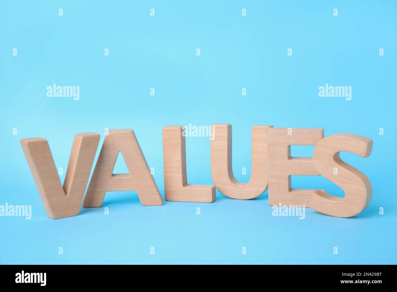 Word VALUES made of wooden letters on light blue background Stock Photo ...