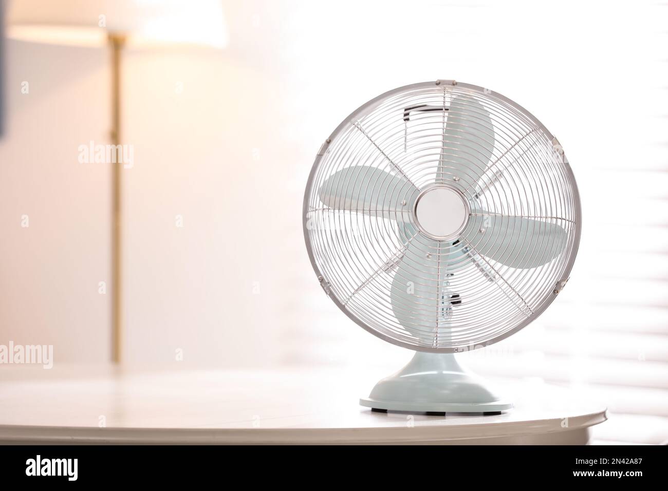 Modern electric fan on white table indoors. Space for text Stock Photo ...