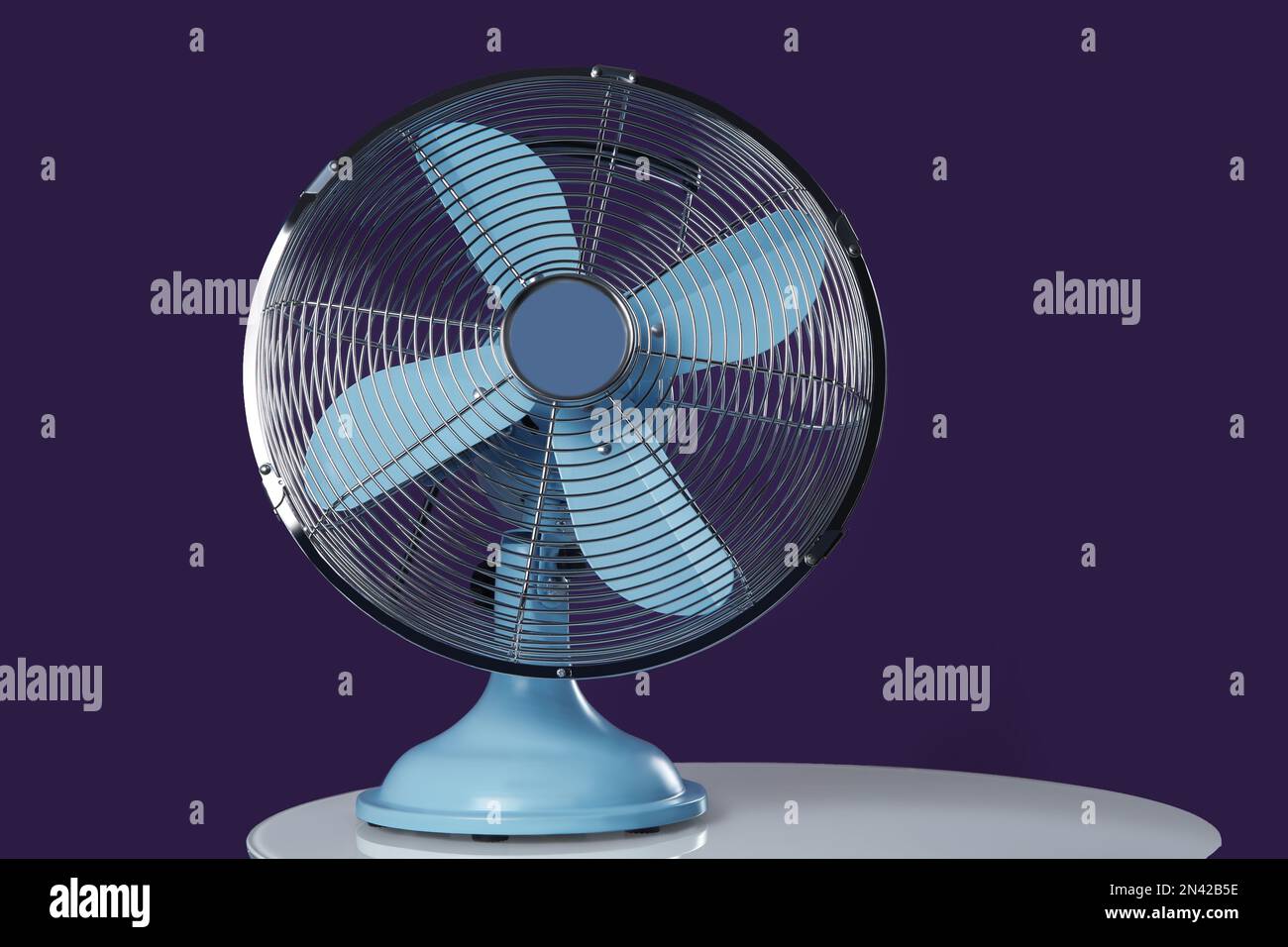 Modern electric fan on white table against violet background Stock ...