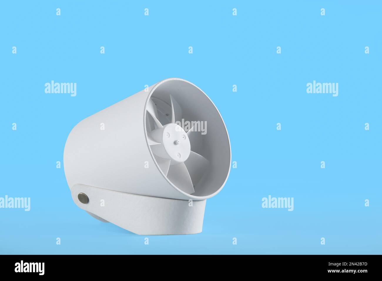 Modern electric fan on light blue background Stock Photo - Alamy