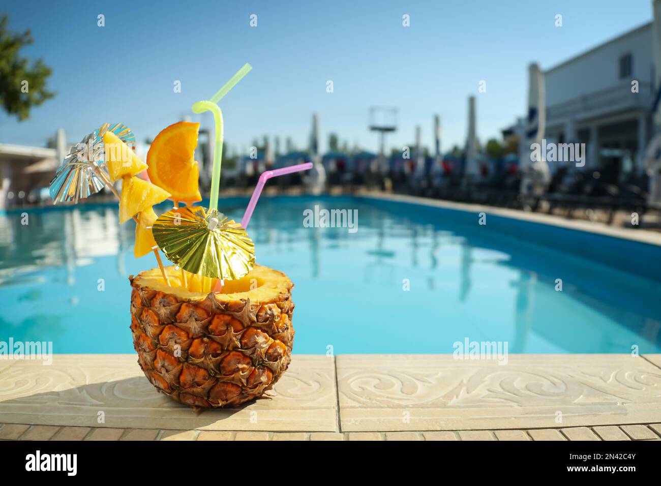 Tasty tropical cocktail on edge of swimming pool. Party drink Stock ...