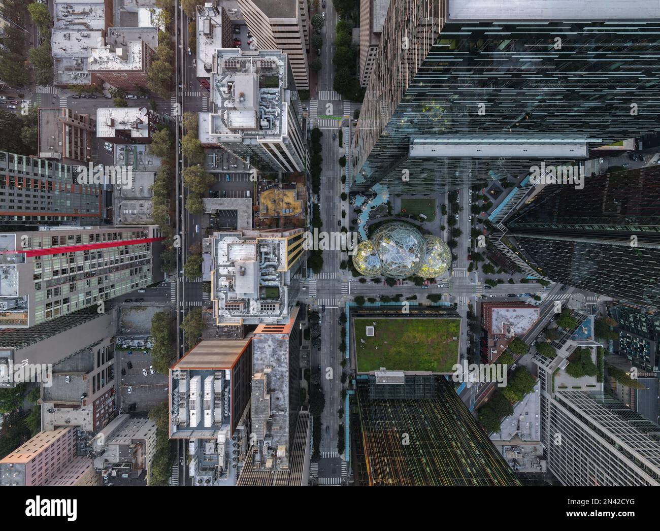 An aerial shot of an urban landscape with tall, modern, glass buildings ...