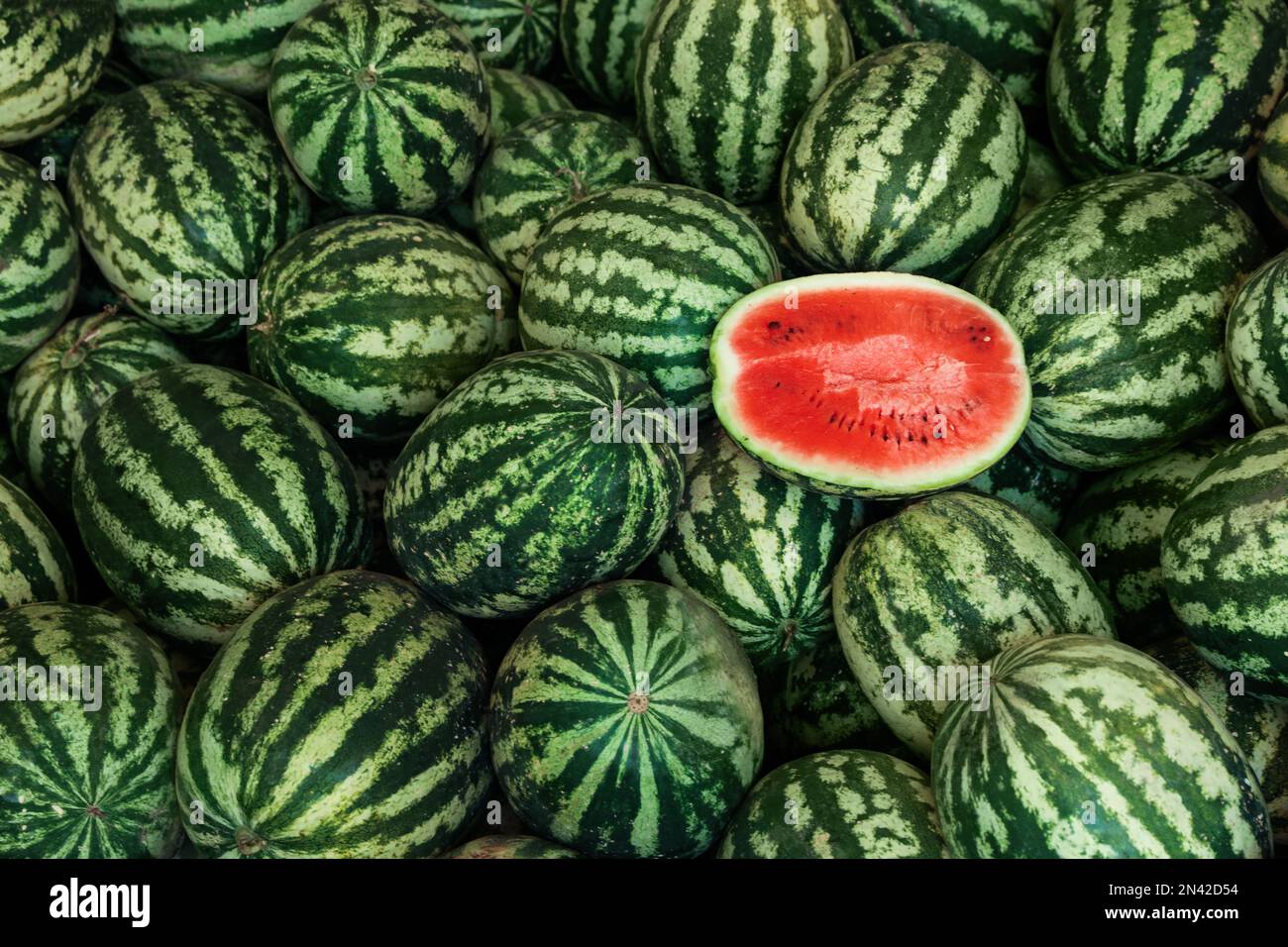 Delicious whole and cut watermelons as background, top view Stock Photo ...