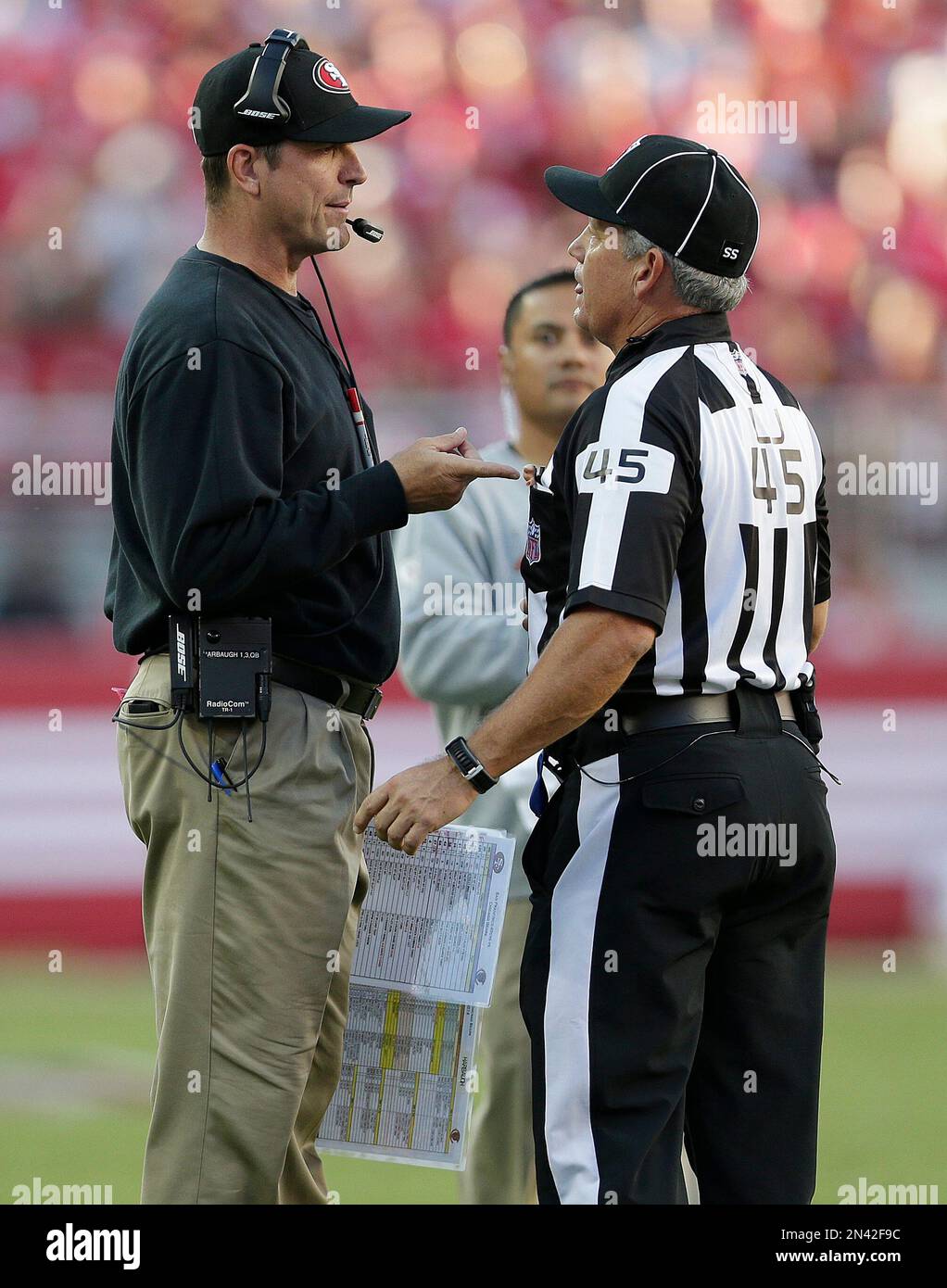 San Francisco 49ers head coach Jim Harbaugh, left, talks with line ...