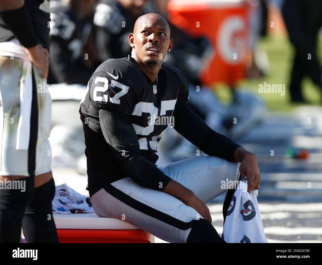 Oakland Raiders cornerback Carlos Rogers sits on the bench late in the ...