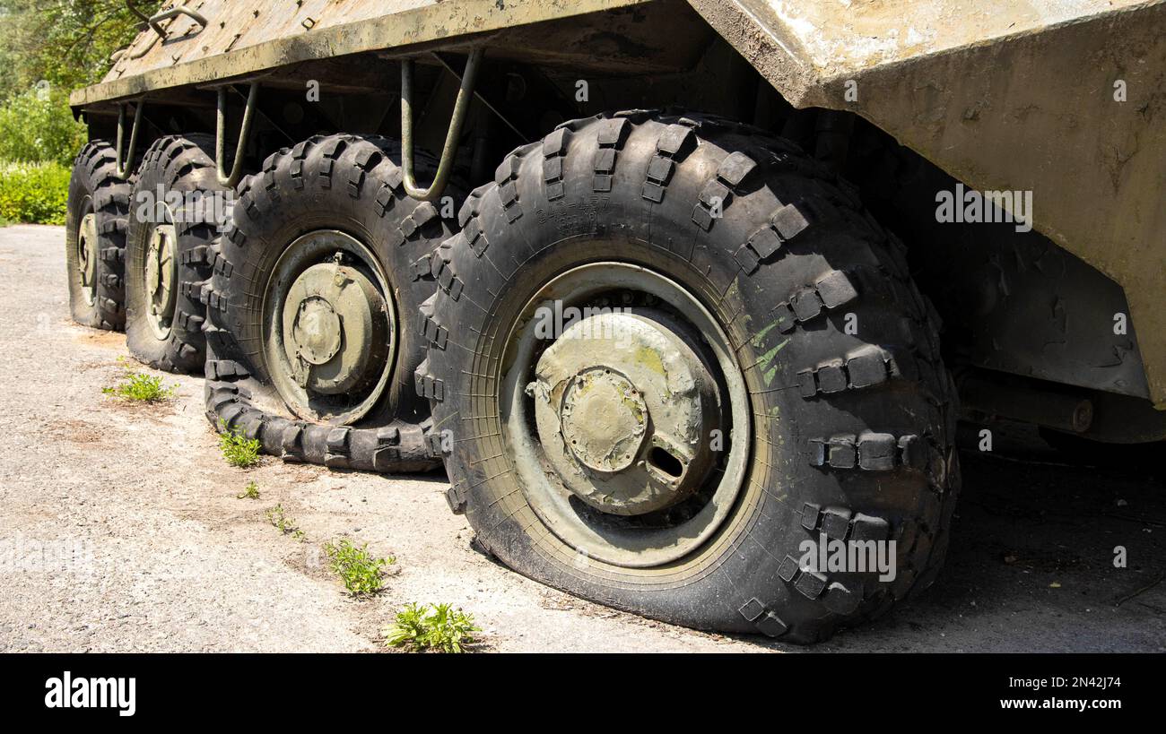 Wheels of armored personnel carriers pierced by bullets during a ...