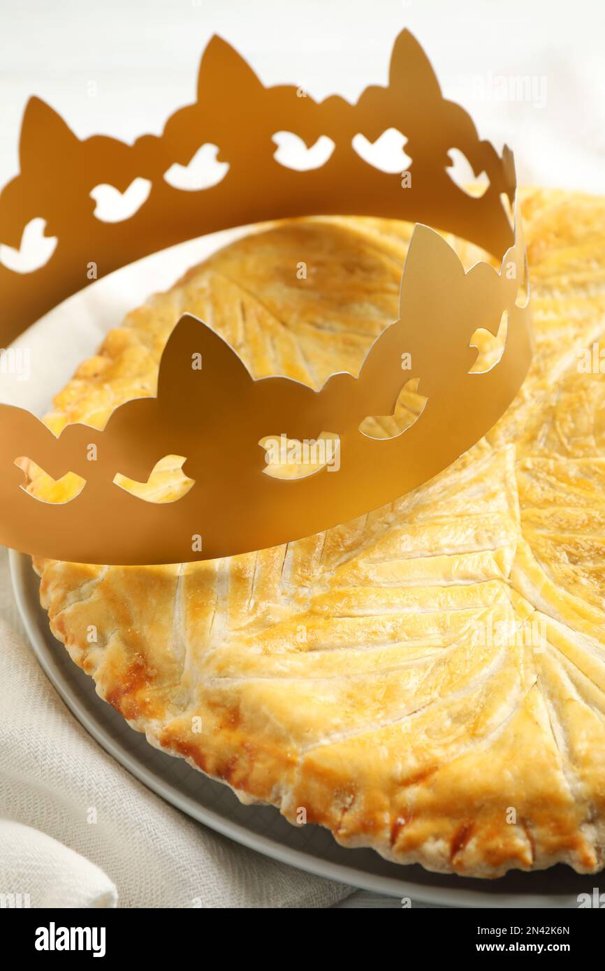 Traditional galette des Rois with paper crown on table, closeup Stock ...