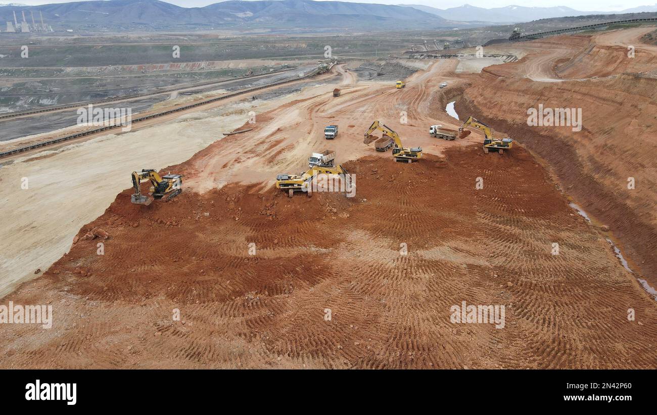 Excavators working. Loading trucks on huge mining site Stock Photo - Alamy