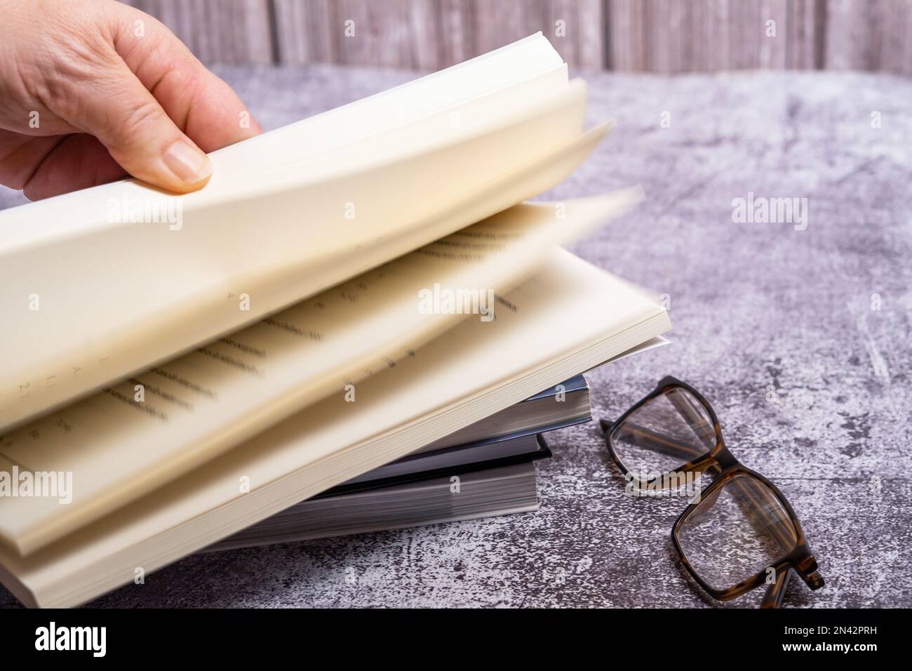 One woman flipping pages book hi-res stock photography and images - Alamy