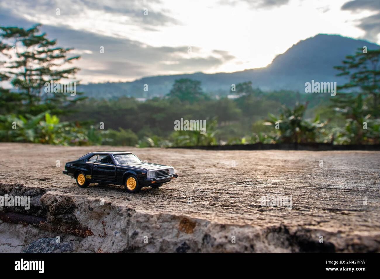 Photo of black toy car on a stone chair, after some edits Stock Photo ...