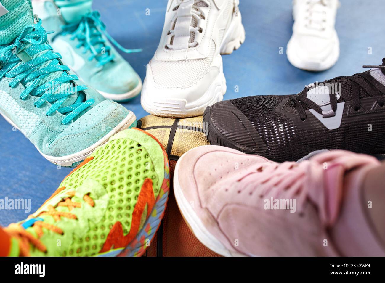 Bright and colorful sport shoes circle with basket ball top view. Set ...