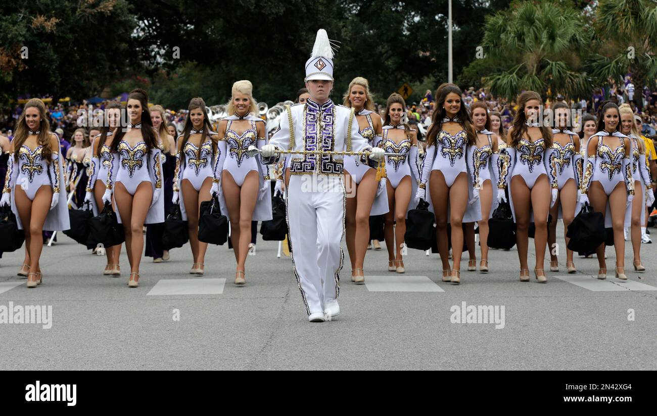 A drum major for the LSU marching band leads the LSU Golden Girls dance ...