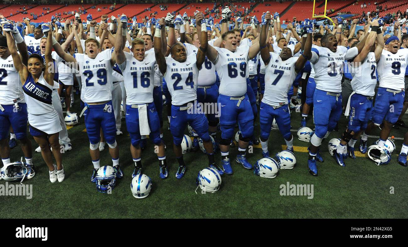 Air Force cheerleaders and football players celebrate a victory over Georgia State after an NCAA ...