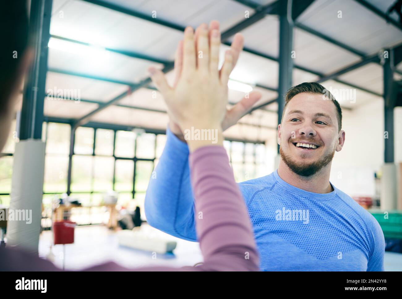 Man, exercise and high five in gym for achievement, target and ...