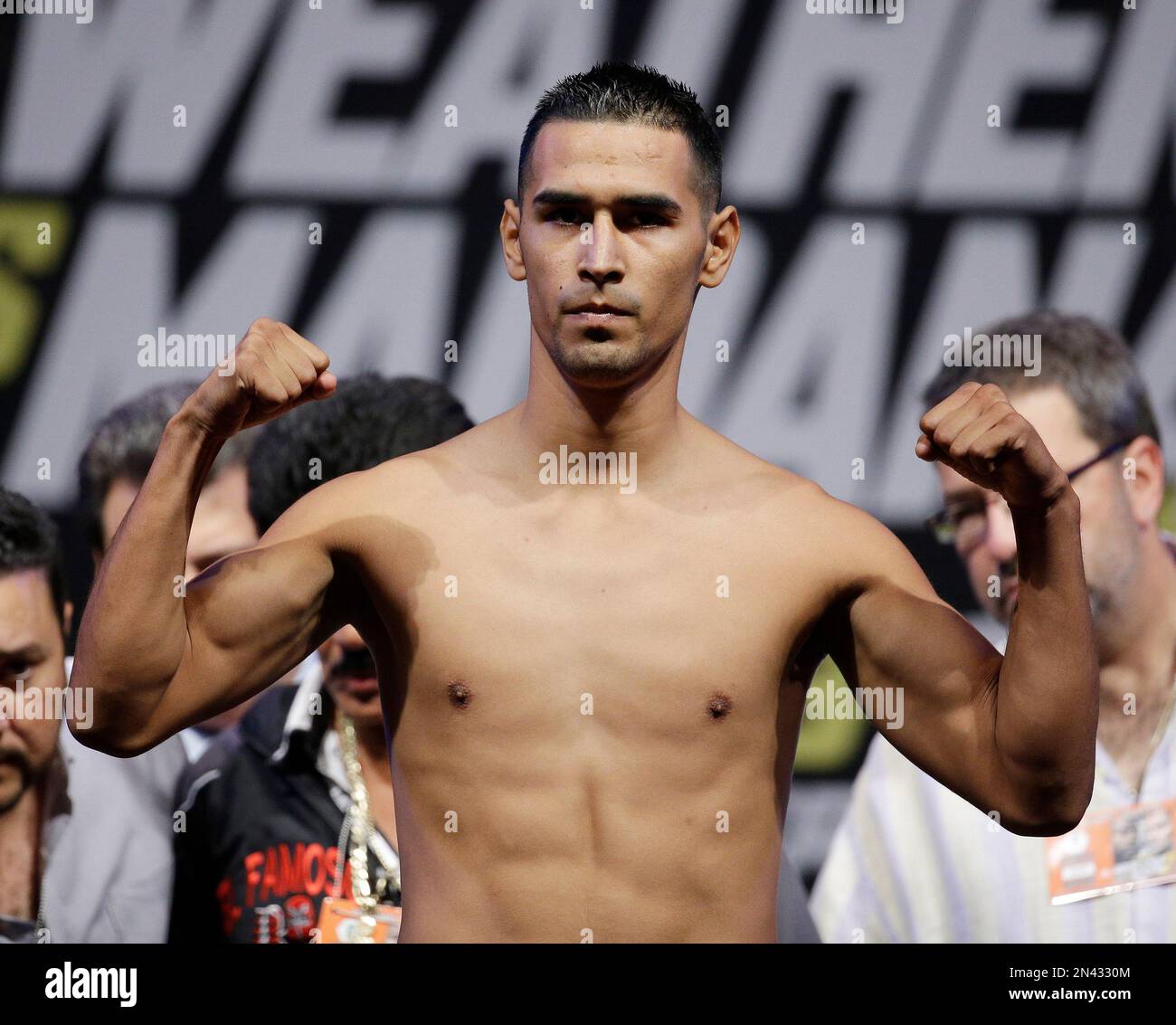 Manuel Roman poses on the scale during a weigh-in Friday, Sept. 12 ...