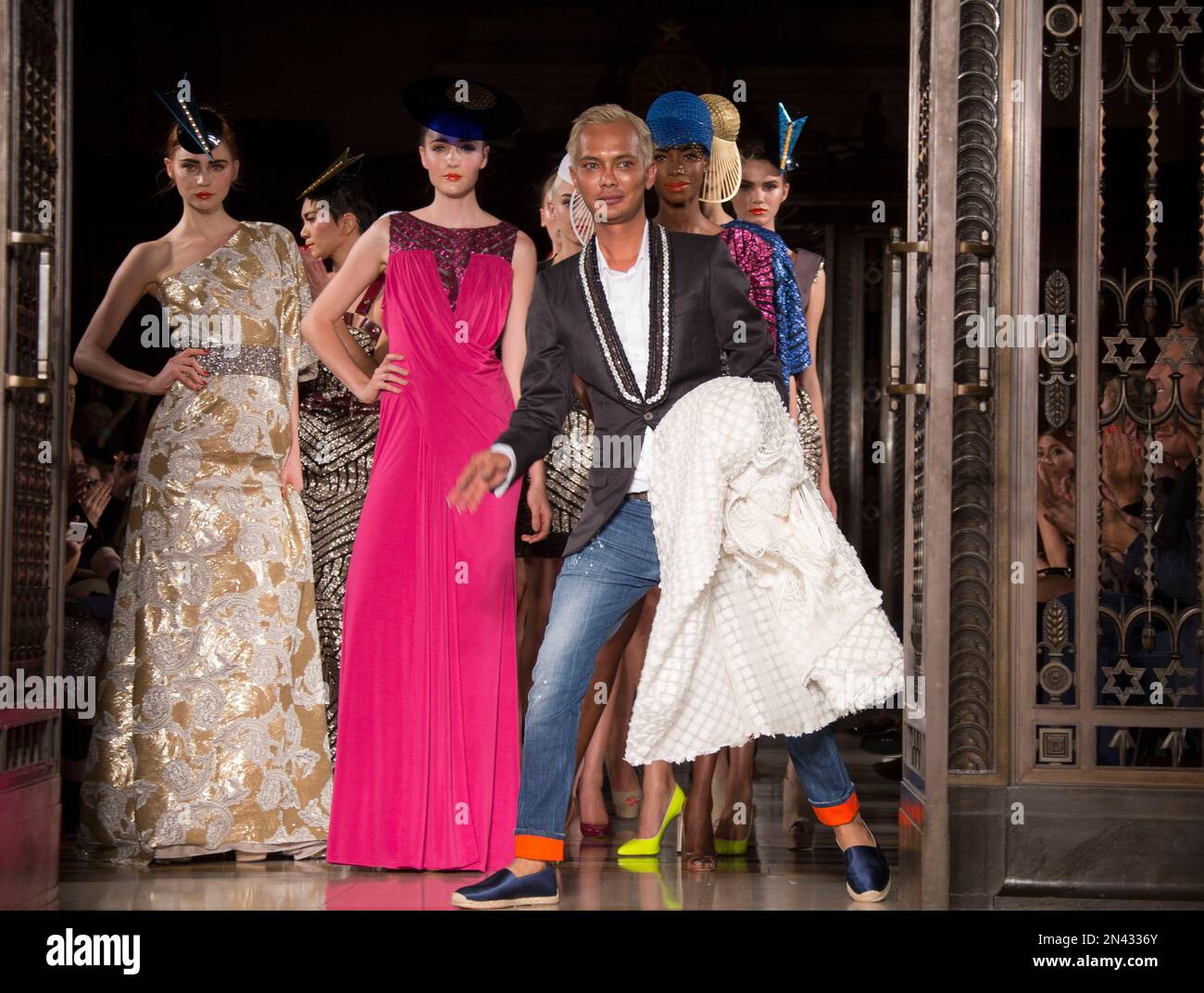 Designer Ashley Isham takes the applause following his show during the ...